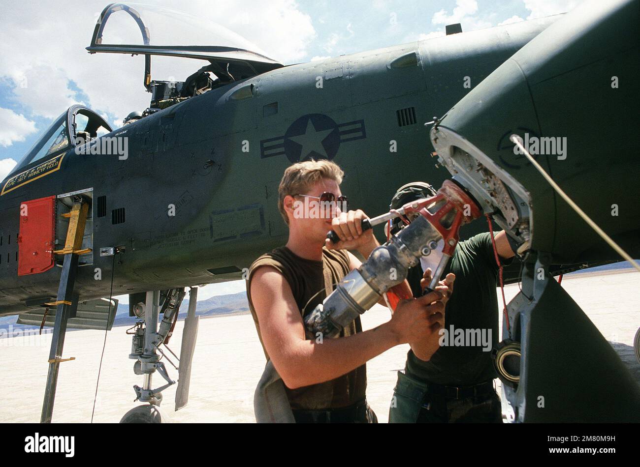 A fuel line is connected to the tank of a A-10 Thunderbolt II aircraft ...