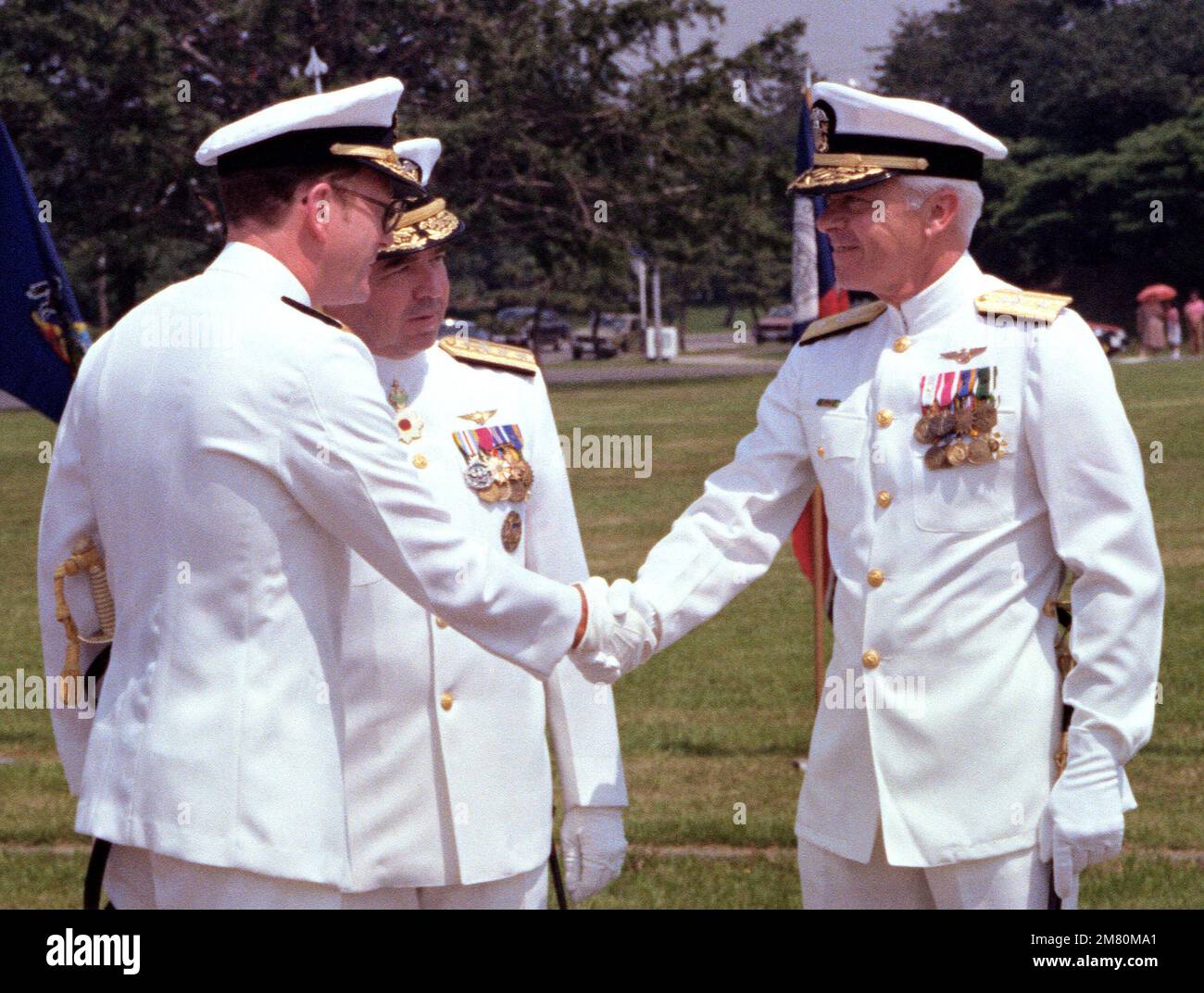 Commodore Willis I. Lewis Jr., right, greets Vice Admiral James R. Hogg ...