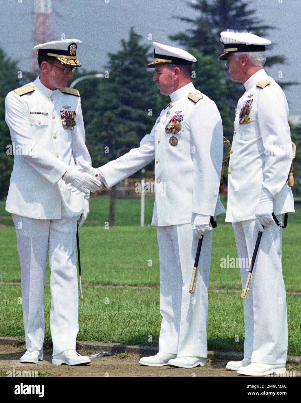 Rear Admiral James W. Austin, center, greets Vice Admiral James R. Hogg ...