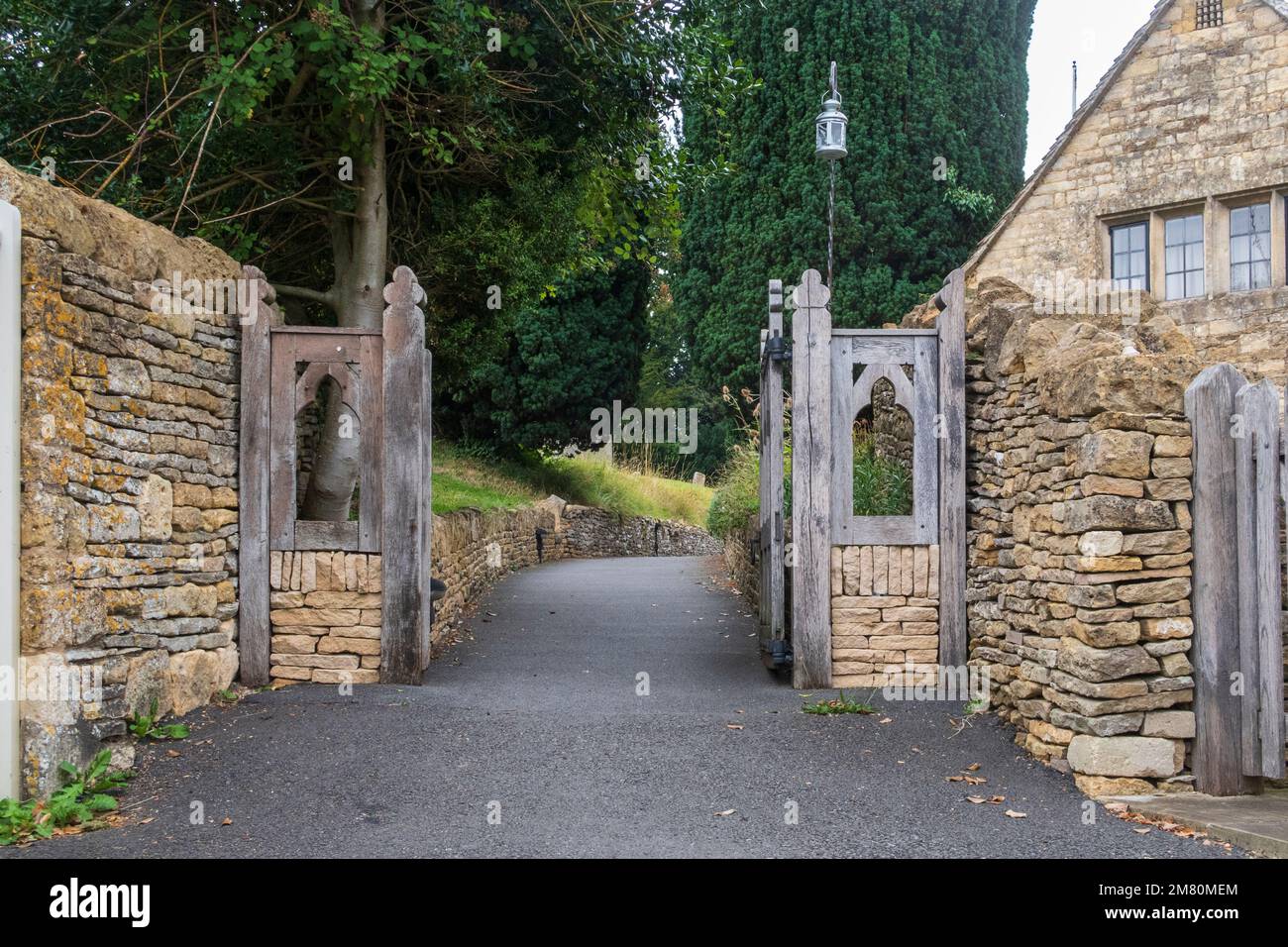 Old Wooden gate entrance to an old English Church in the Cotswolds ...