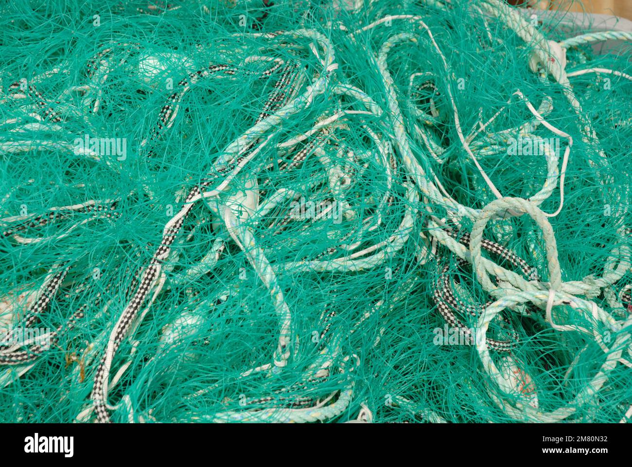 Green fishing net in a heap Stock Photo - Alamy