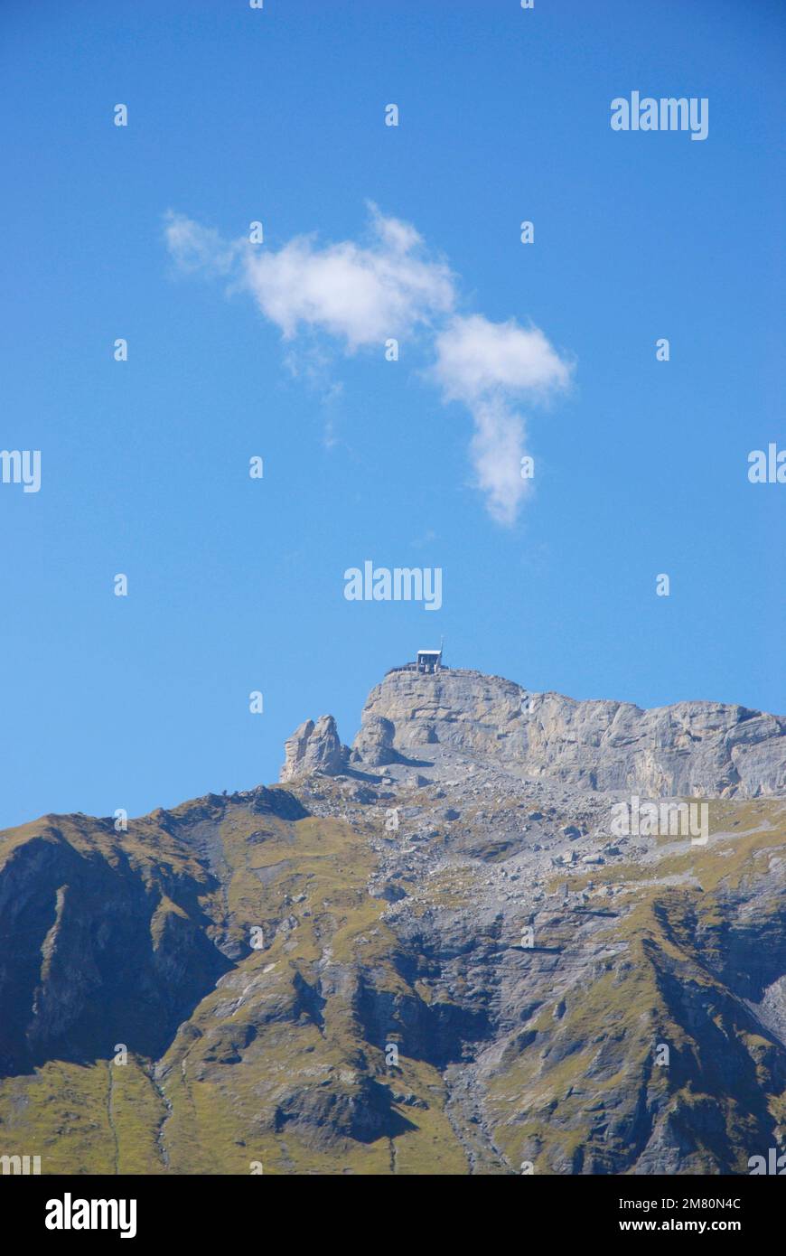 There is a small alpine hut on the top of the mountain Stock Photo - Alamy