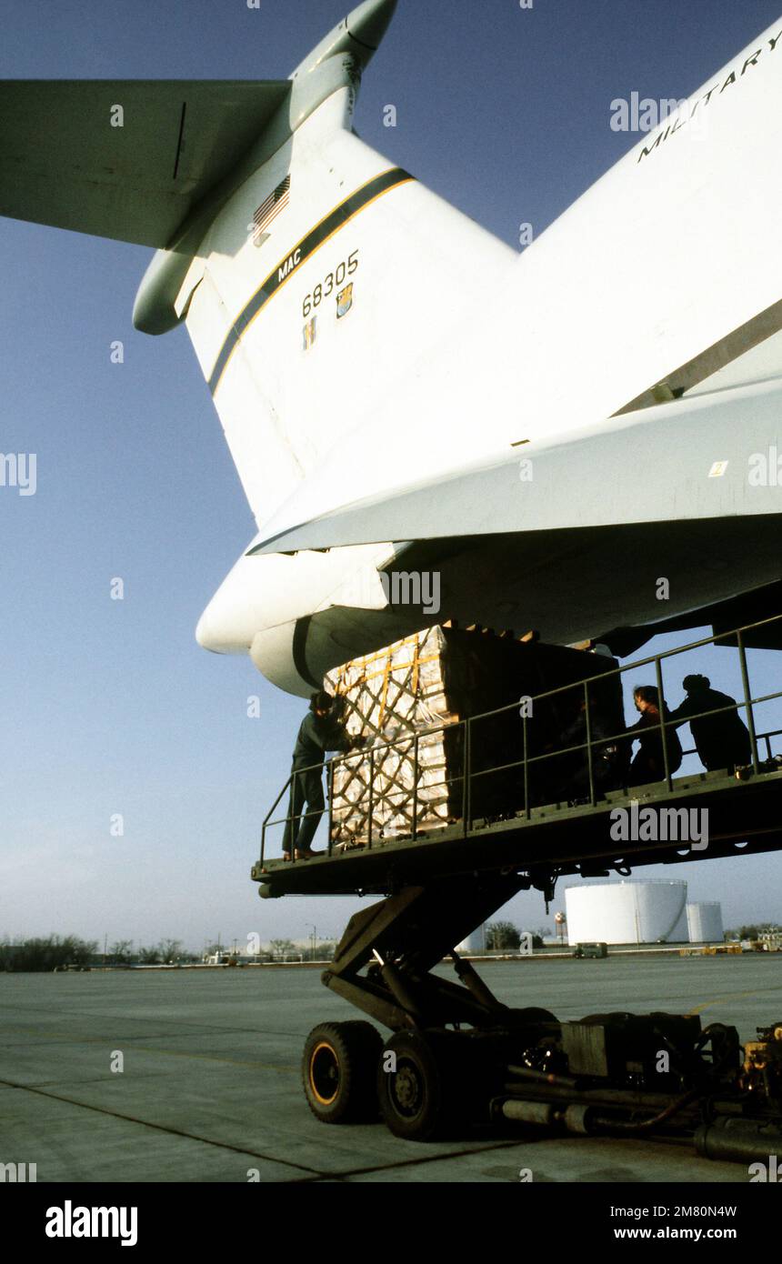Cargo is loaded aboard a C-5A Galaxy aircraft from the Military Airlift ...