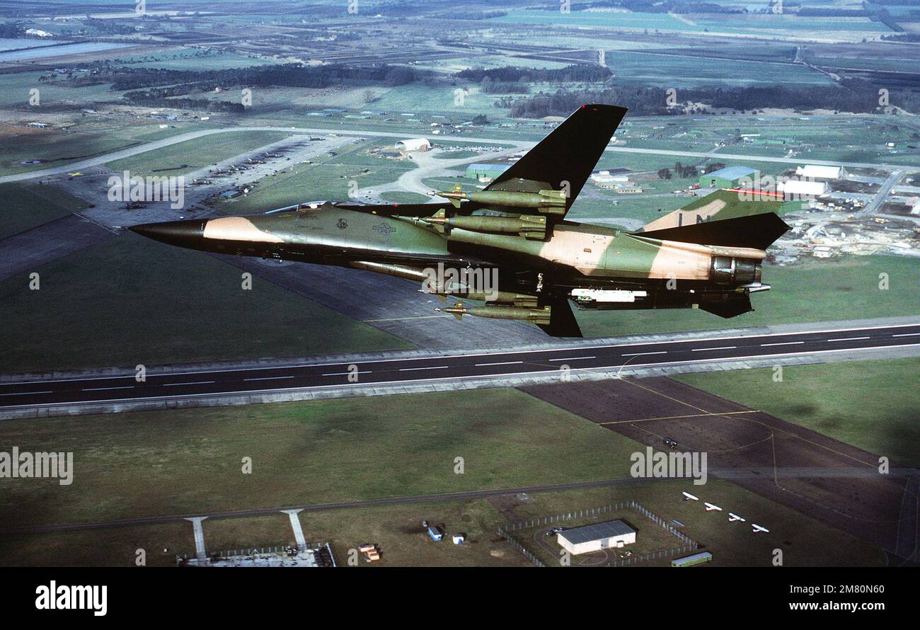 An air-to-air left underside view of an F-111 aircraft flown by the ...