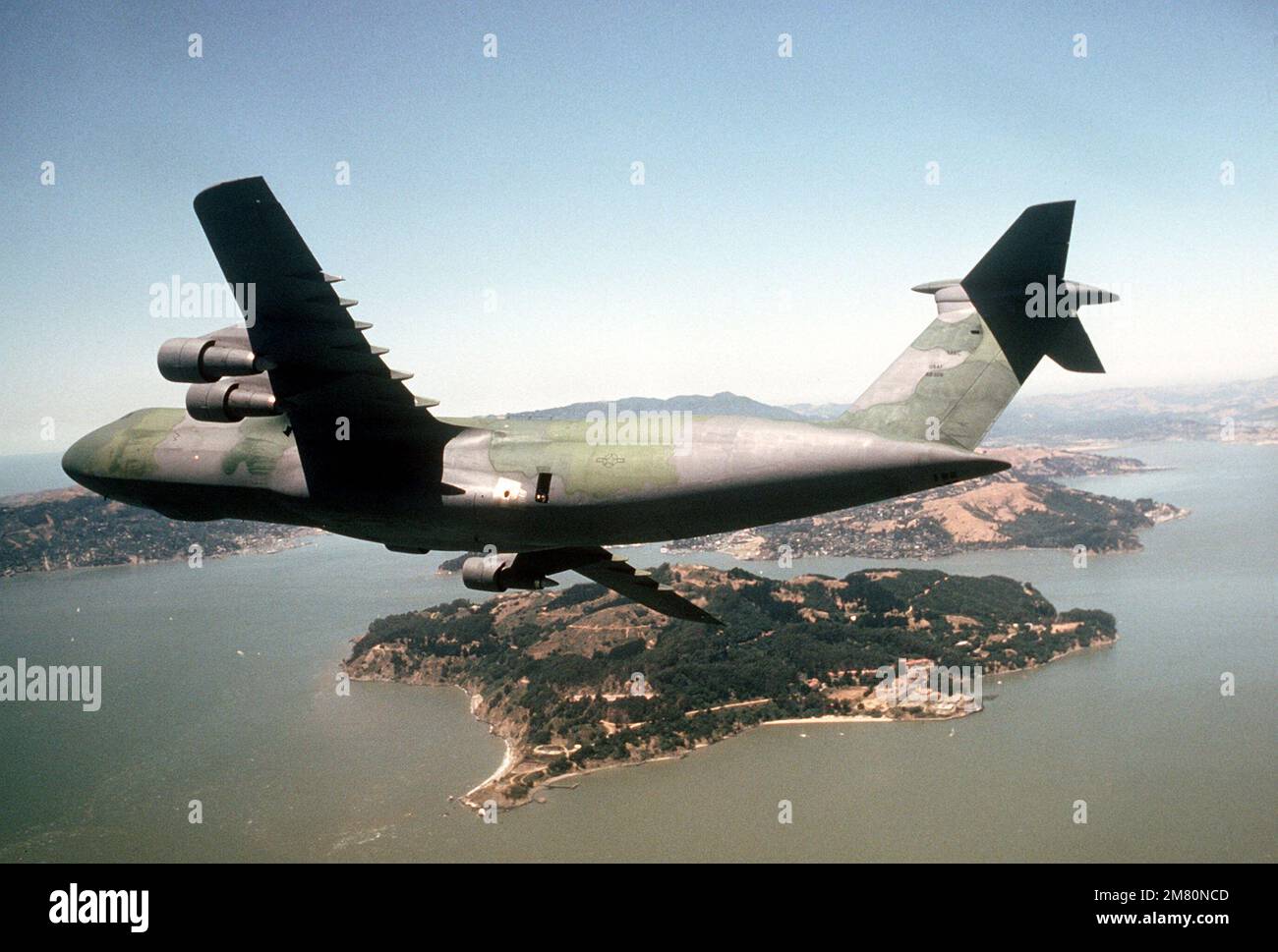 An air-to-air front view of a C-5 Galaxy aircraft over San Francisco ...