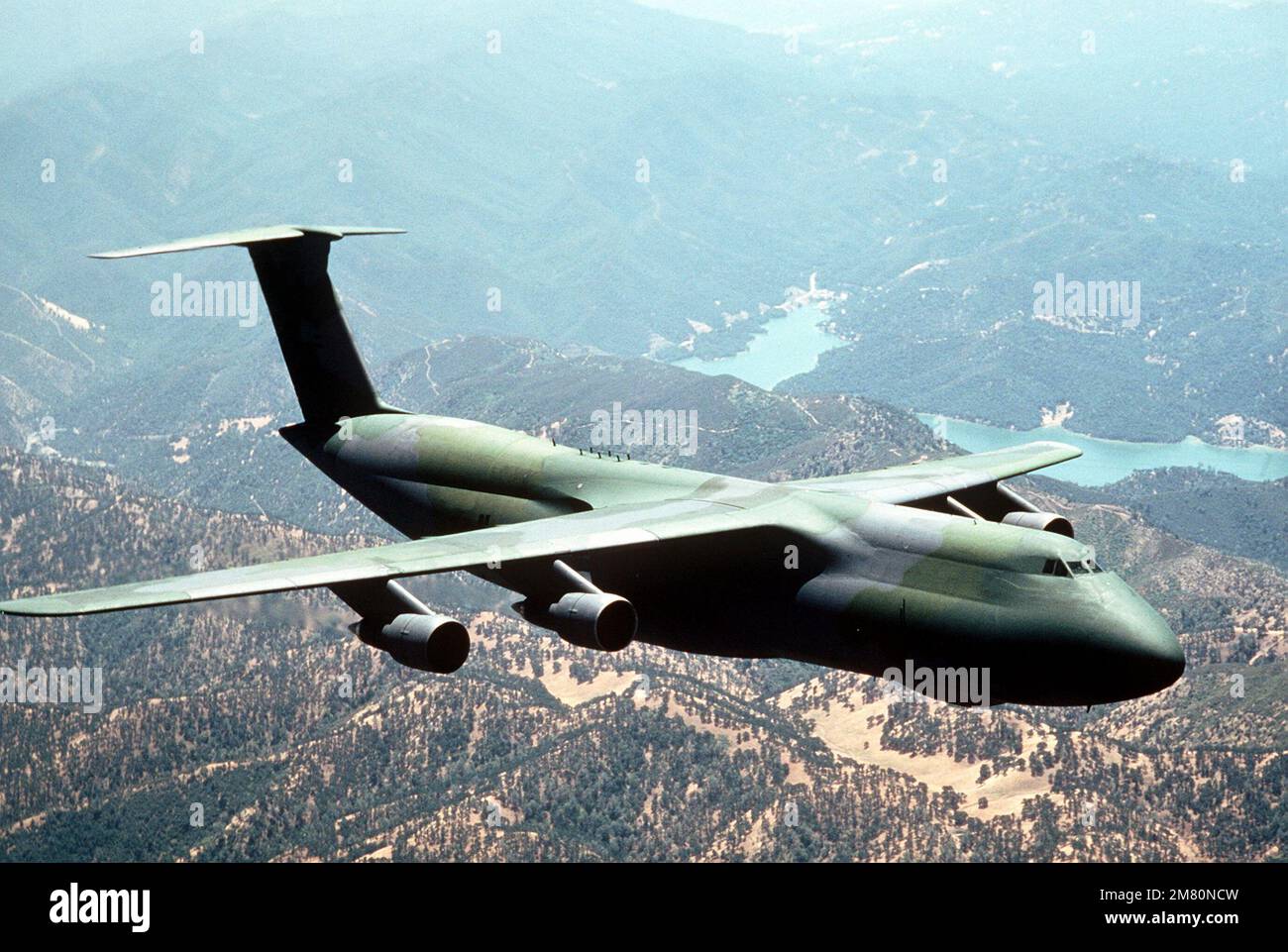 An air-to-air front view of a C-5 Galaxy aircraft over Lake Berryessa ...