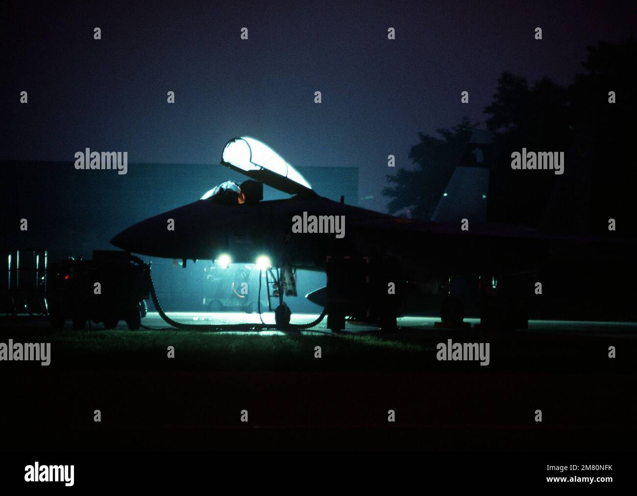 Left front view of an F-15 Eagle aircraft at night, as a post-flight ...