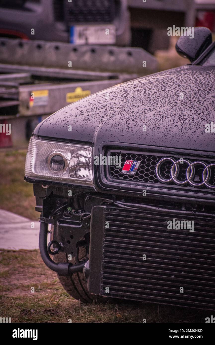 A closeup of an Audi S2 headlight, front grill and big intercooler ...