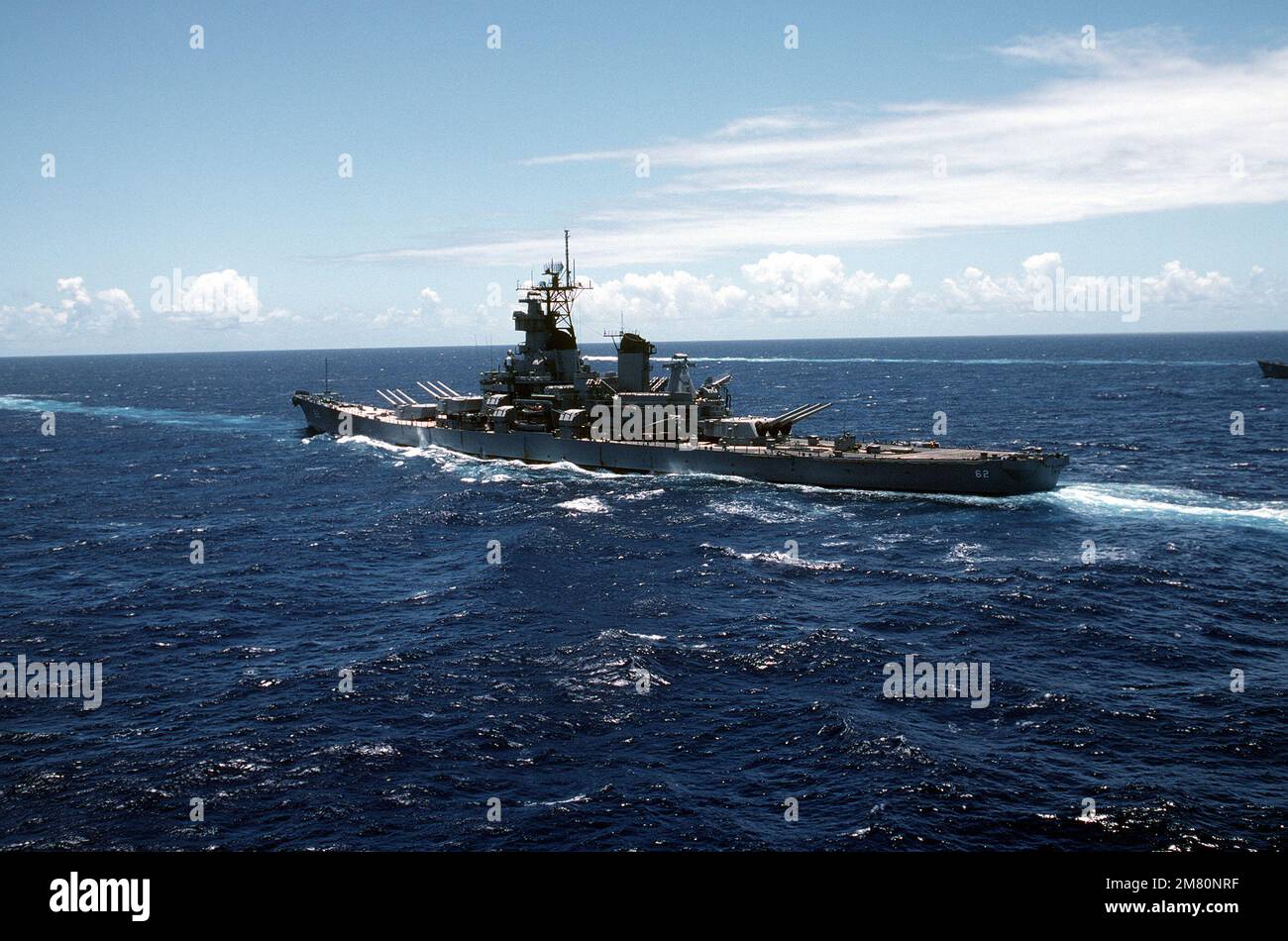 An aerial port quarter view of the battleship USS NEW JERSEY (BB-62 ...