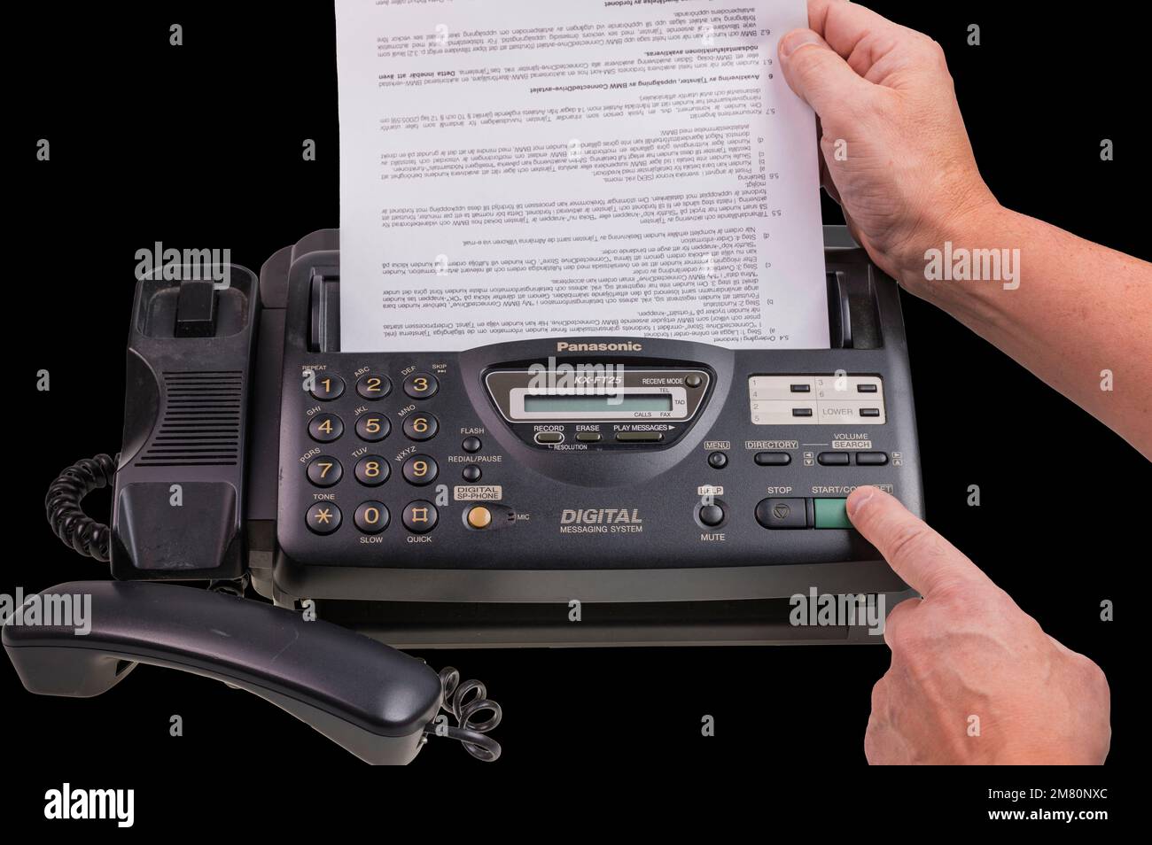 Close up view of person's hands sending fax on Panasonic fax phone ...