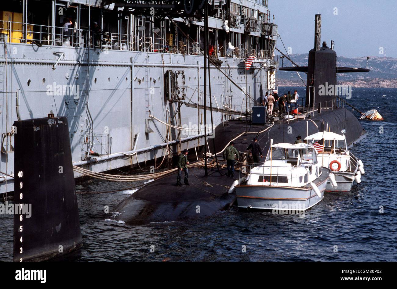 The Fulton-class submarine tender USS ORION (AS 18) services a ...