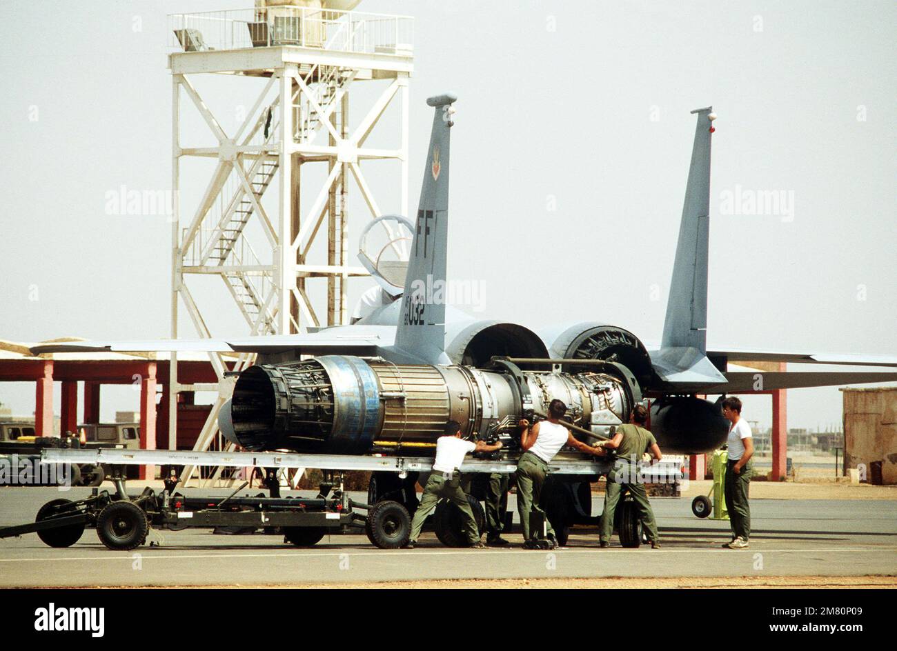 An F-15 Eagle aircraft undergoes an engine change during Arid Farmer, a ...