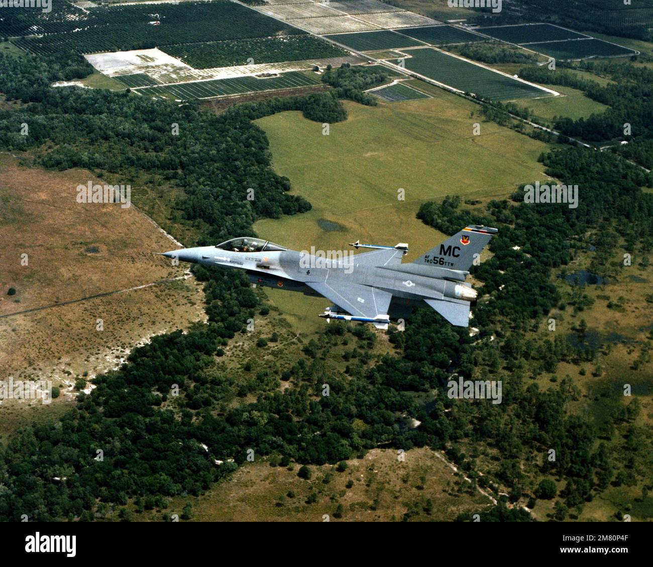 An air-to-air left side view of an F-16A Fighting Falcon aircraft from ...