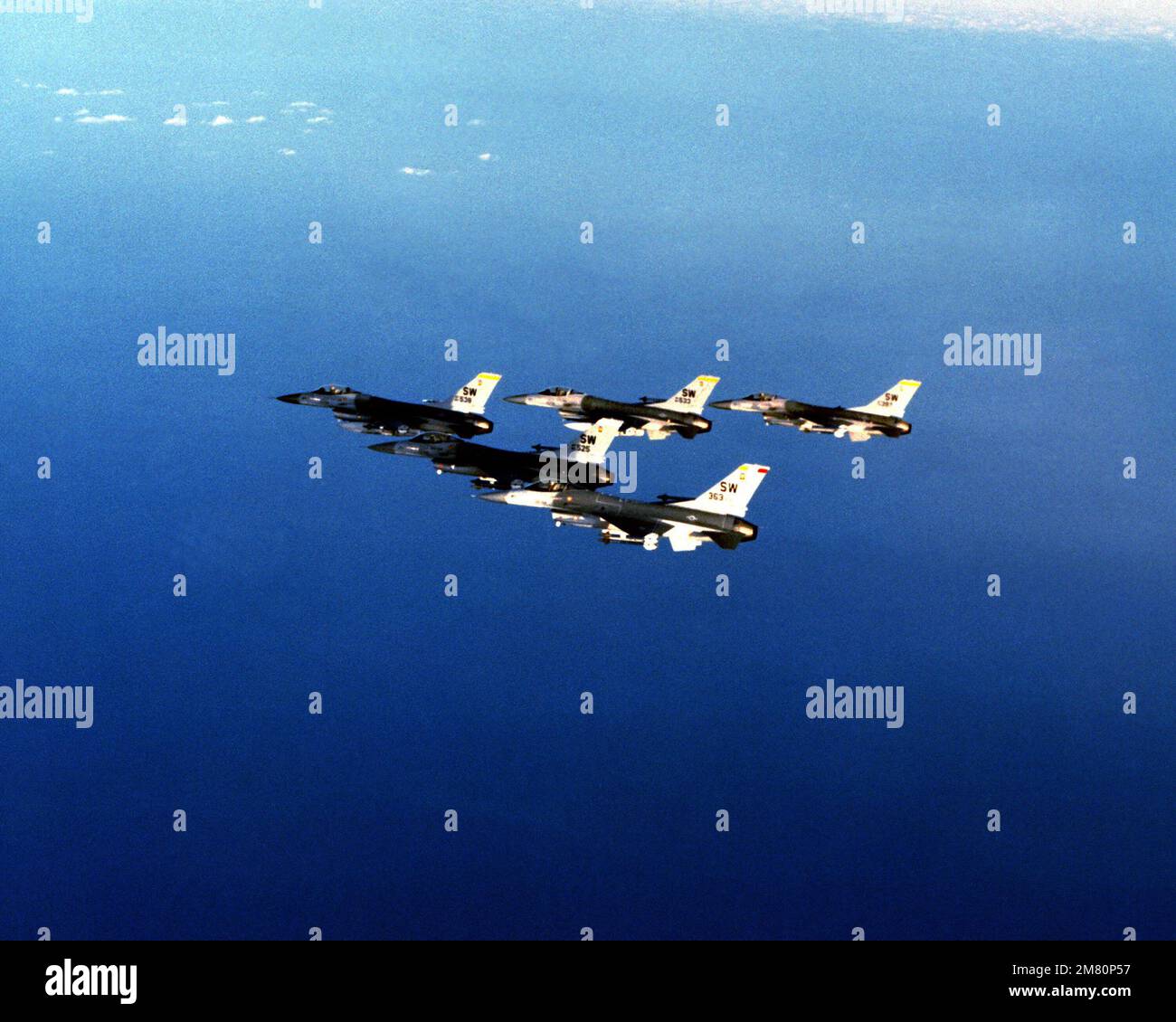 An air-to-air right left side view of five F-16A Fighting Falcon ...