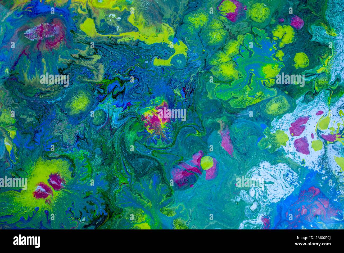 Mixture of liquid acrylic colors creating a marbled texture of bright ...