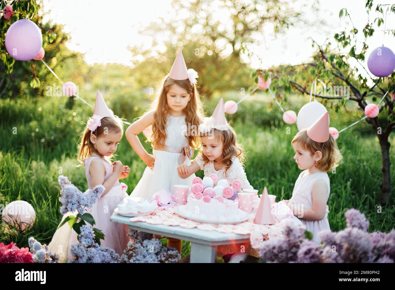 Summer outdoor kids birthday party. Group of happy Children celebrating ...