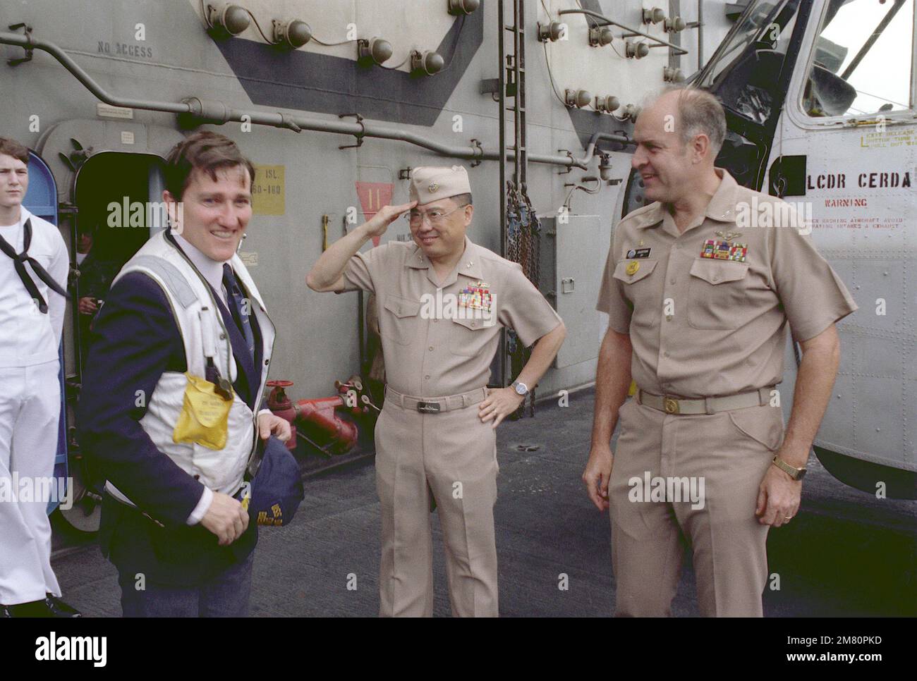 Secretary of the Navy John F. Lehman Jr., left, receives a salute from ...