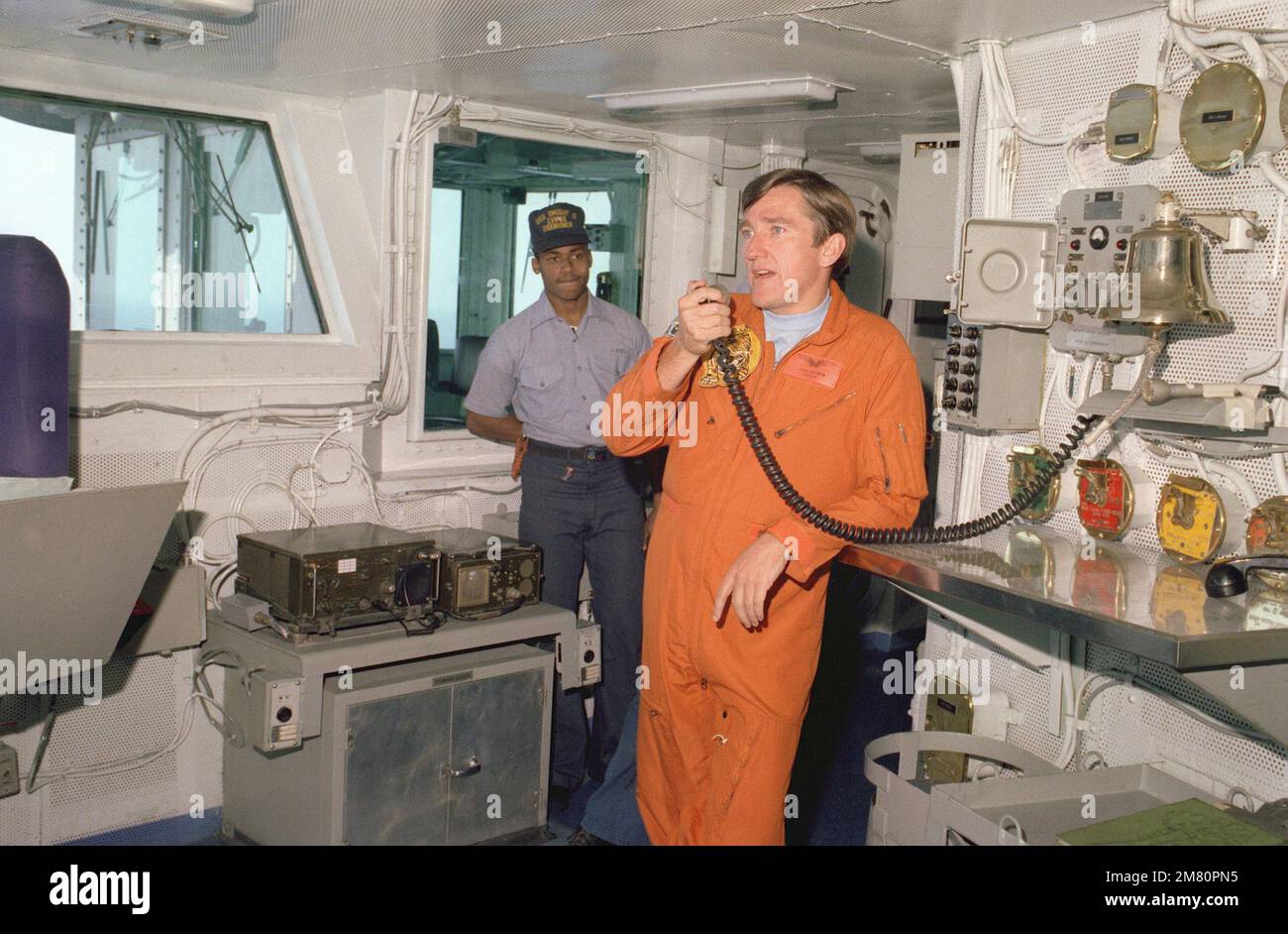 Secretary of the Navy John F. Lehman Jr. speaks to the crew by intercom ...