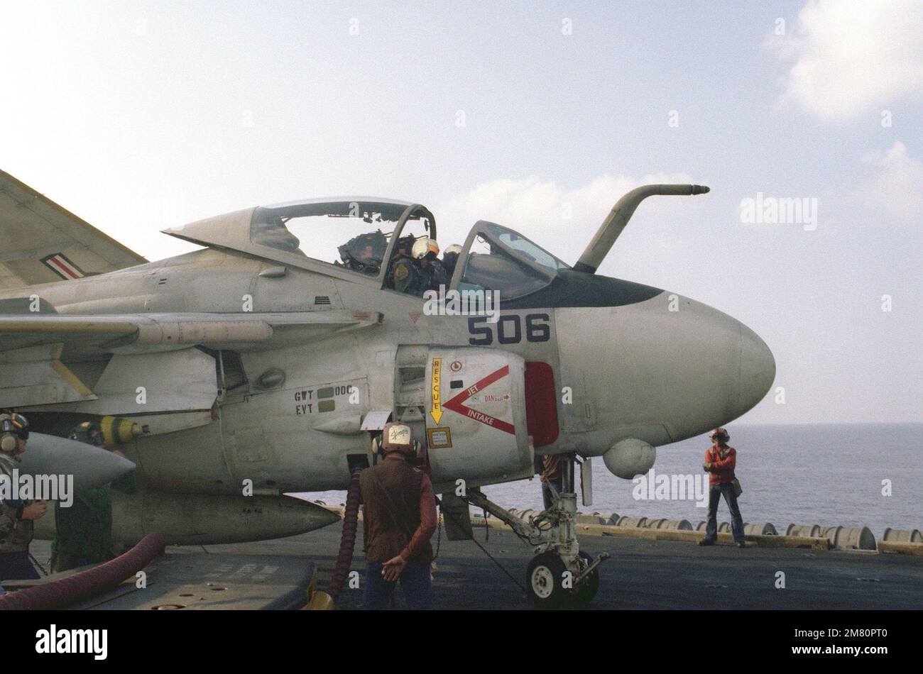 Secretary of the Navy John F. Lehman Jr. straps himself into an Attack ...