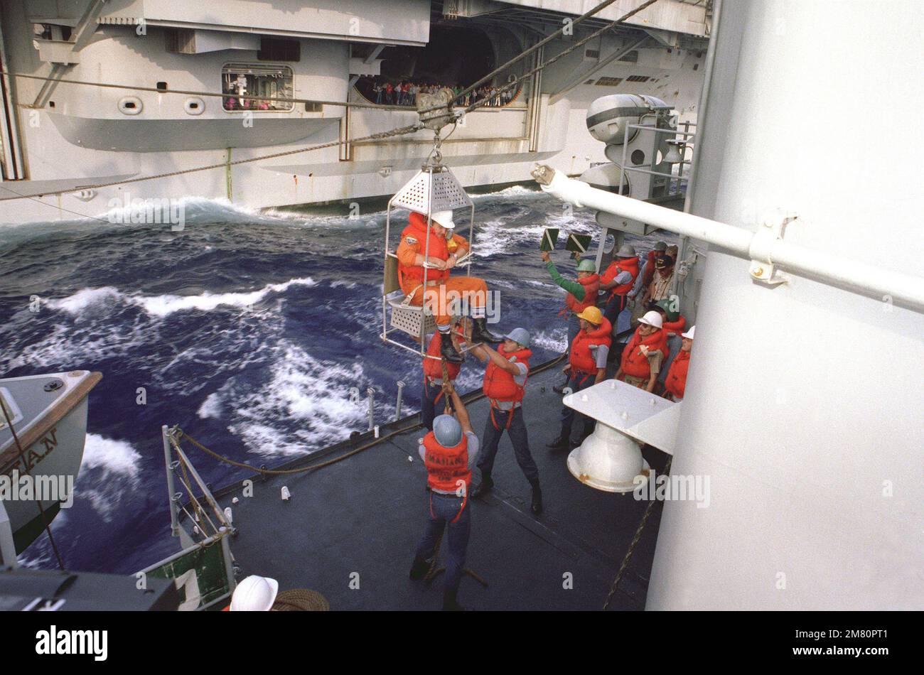 Secretary of the Navy John F. Lehman Jr. is highlined from the nuclear ...