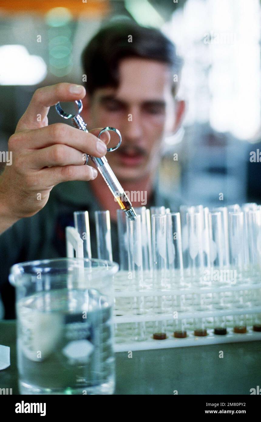 An airman tests samples of jet fuel to determine if any metal fragments ...