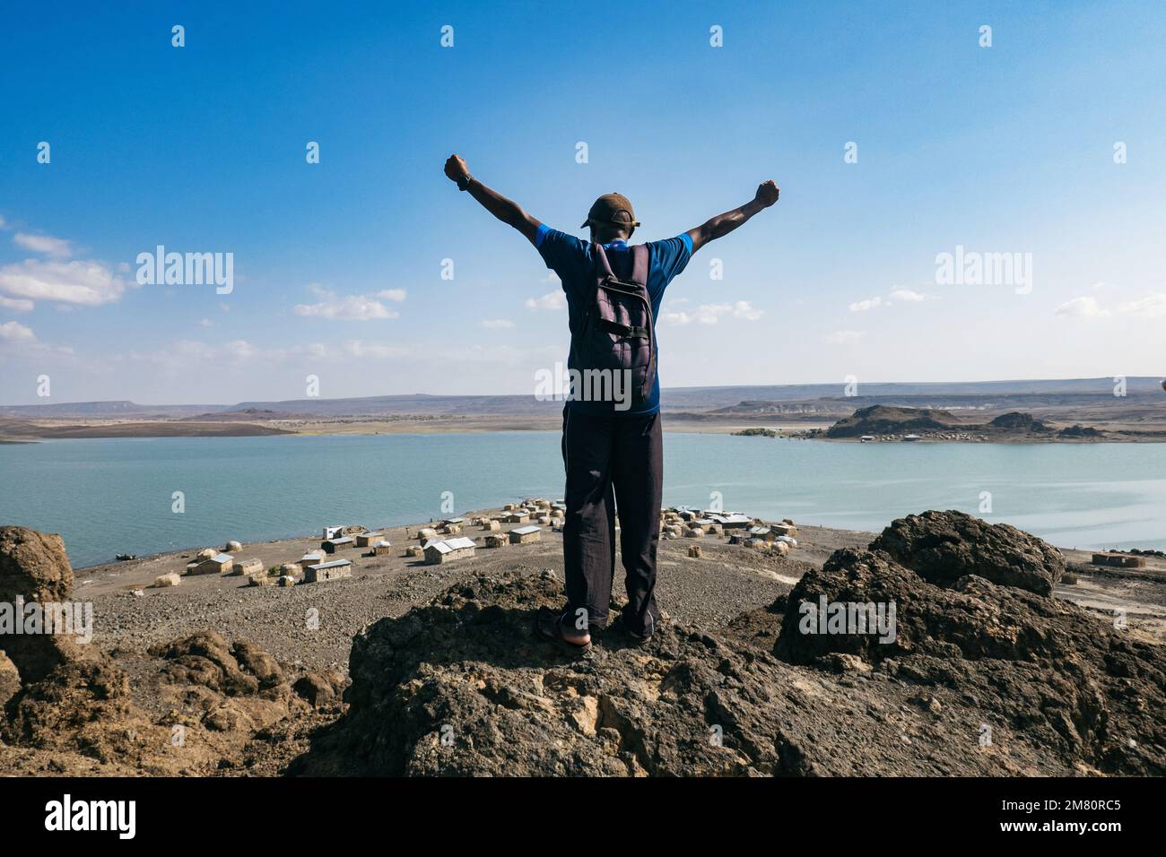 Rear view of a tourist against the background of El Molo Village, Kenya ...