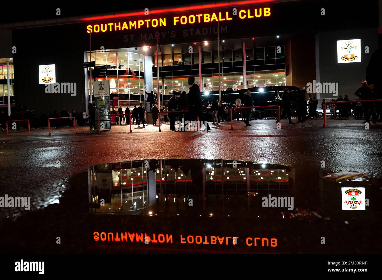 A reflection of the stadium is shown in a rain puddle before the ...
