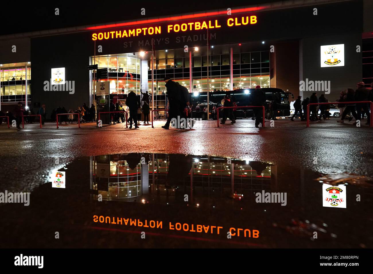A reflection of the stadium is shown in a rain puddle before the ...