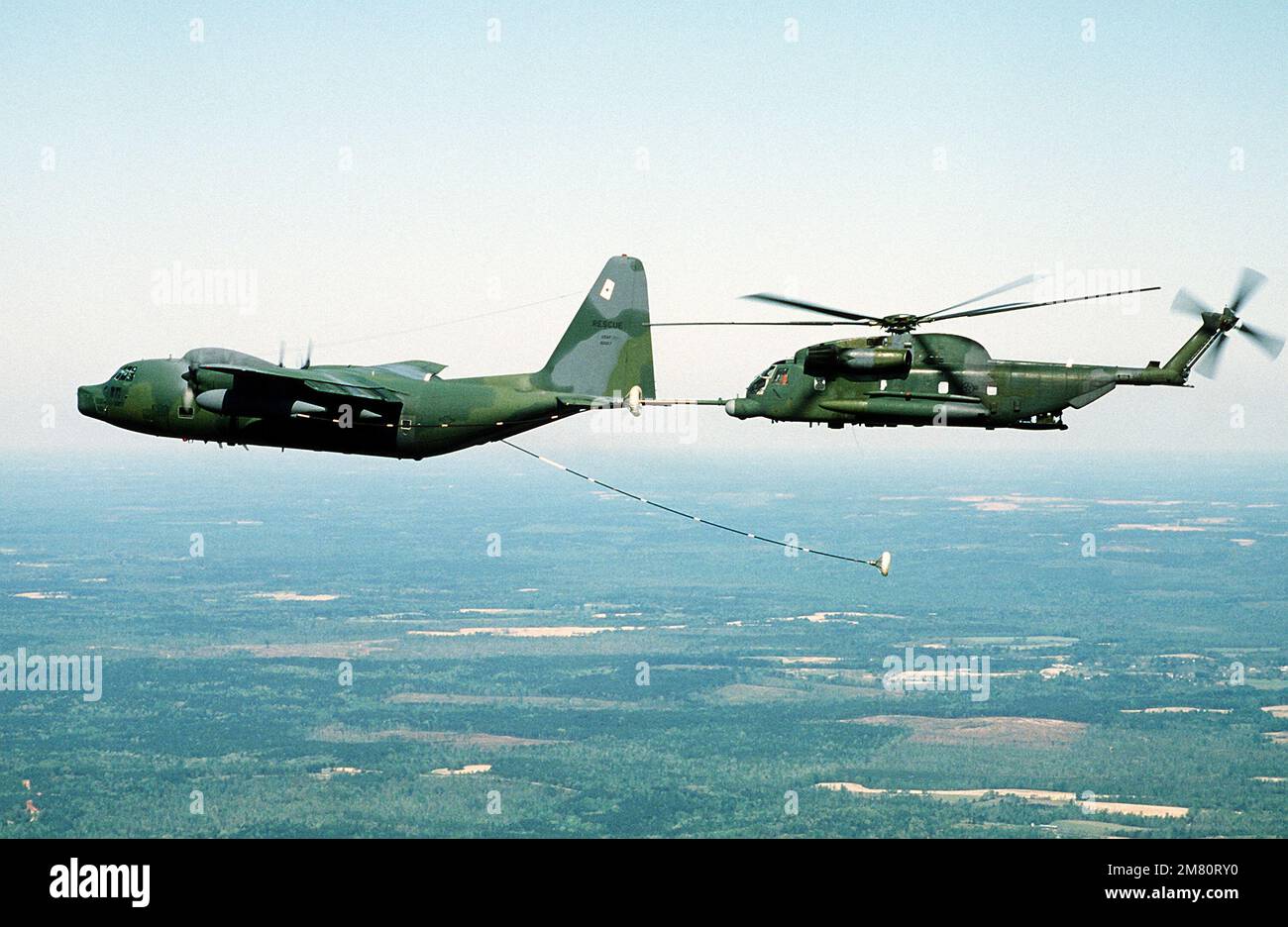 An air-to-air left side view of an HH-53 Pave Low helicopter from the ...