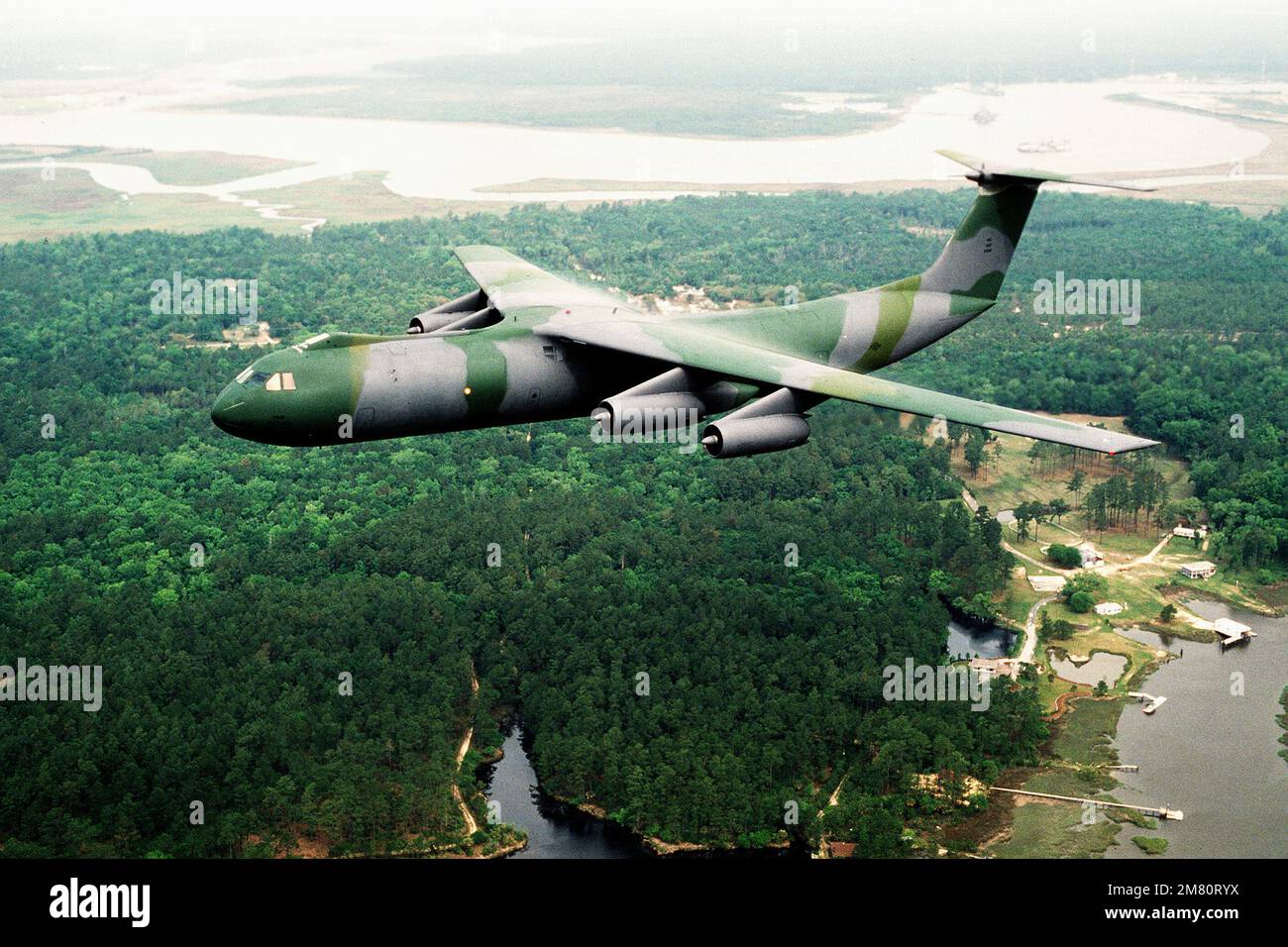 An air-to-air left front view of a 437th Military Airlift Wing C-141 ...