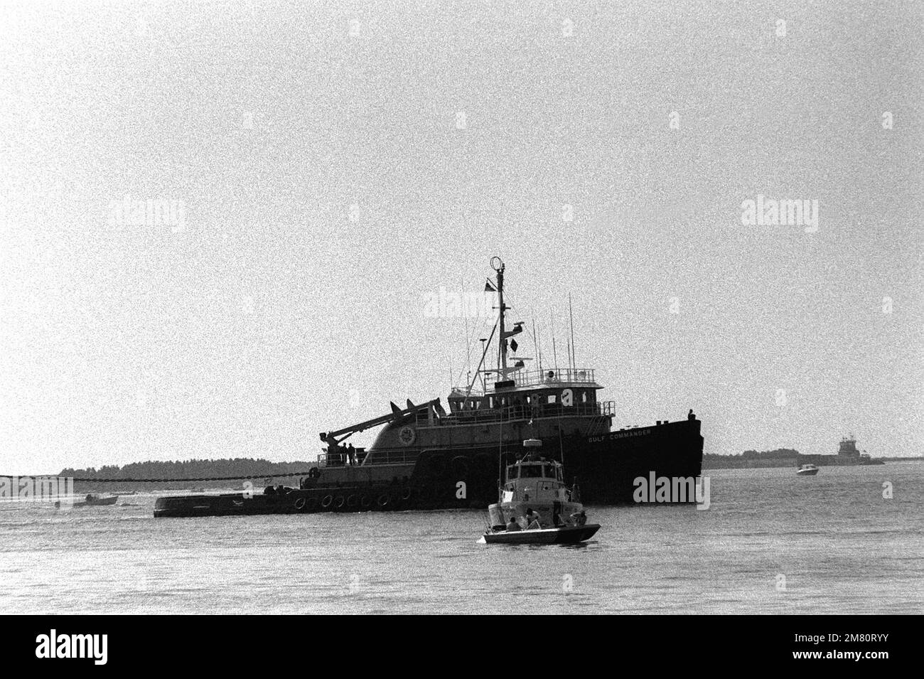 A starboard bow view of the tugboat Gulf Commander towing the ...