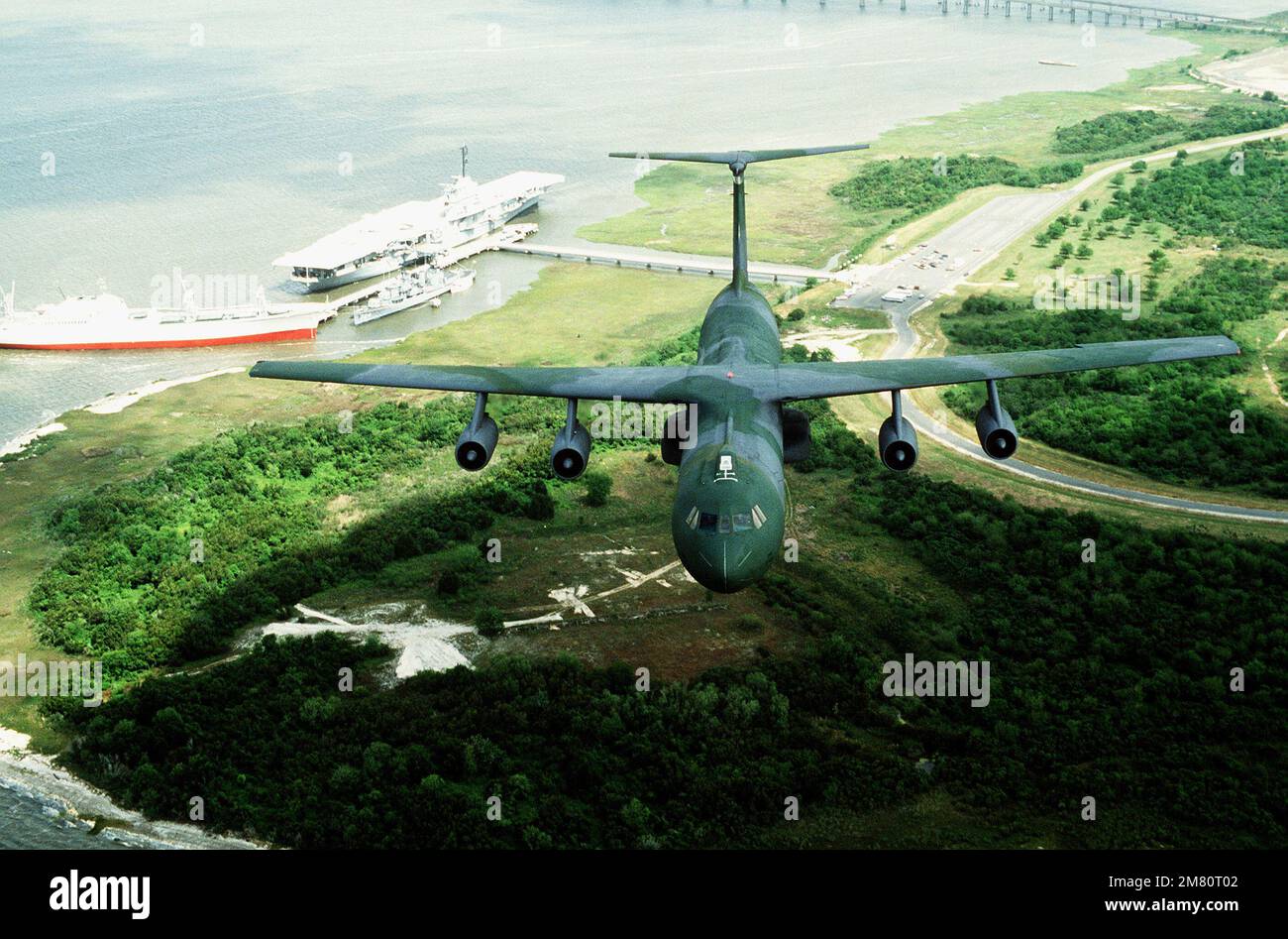 An air-to-air front view of a C-141 Starlifter aircraft in camouflage ...