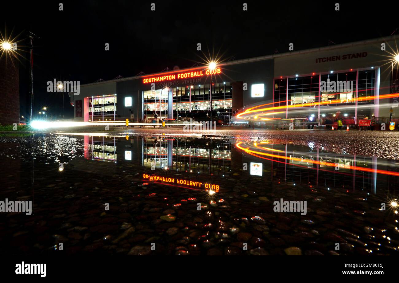 A reflection of the stadium is shown in a rain puddle before the ...
