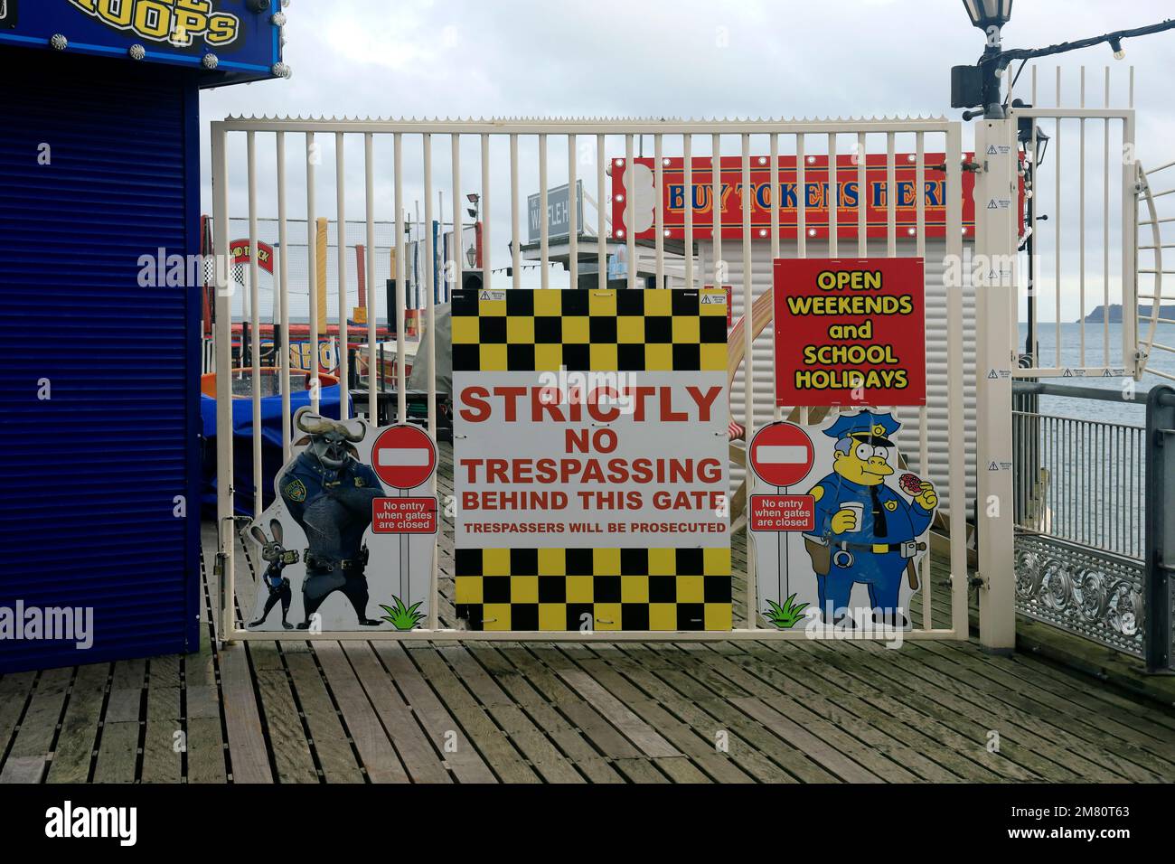 Comic Strictly No Trespassing sign on a closed gate at Paignton pier ...