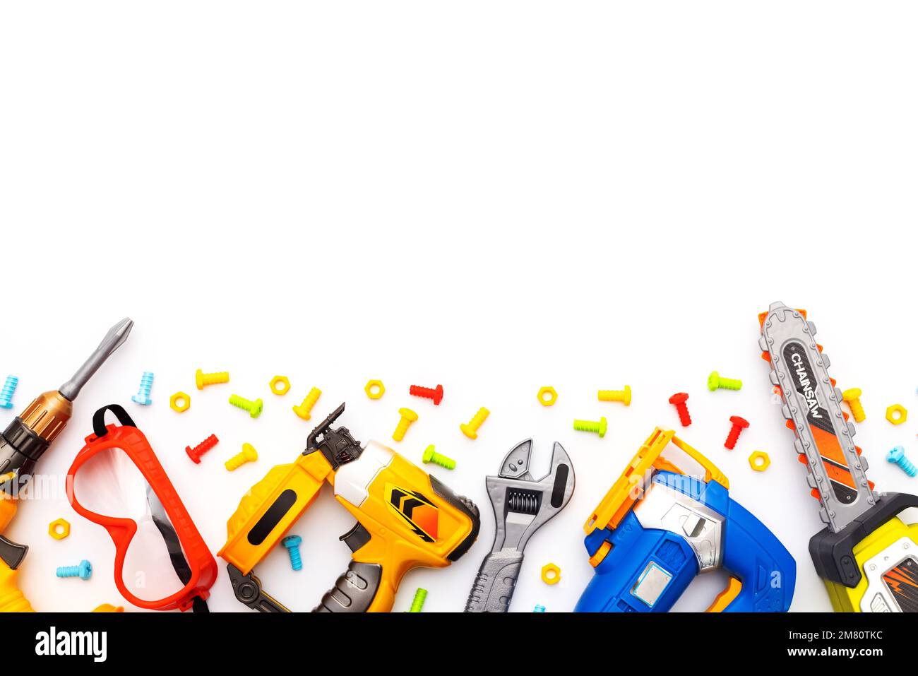 Colorful kids toy tools on white background. Flat lay. Copy space for ...