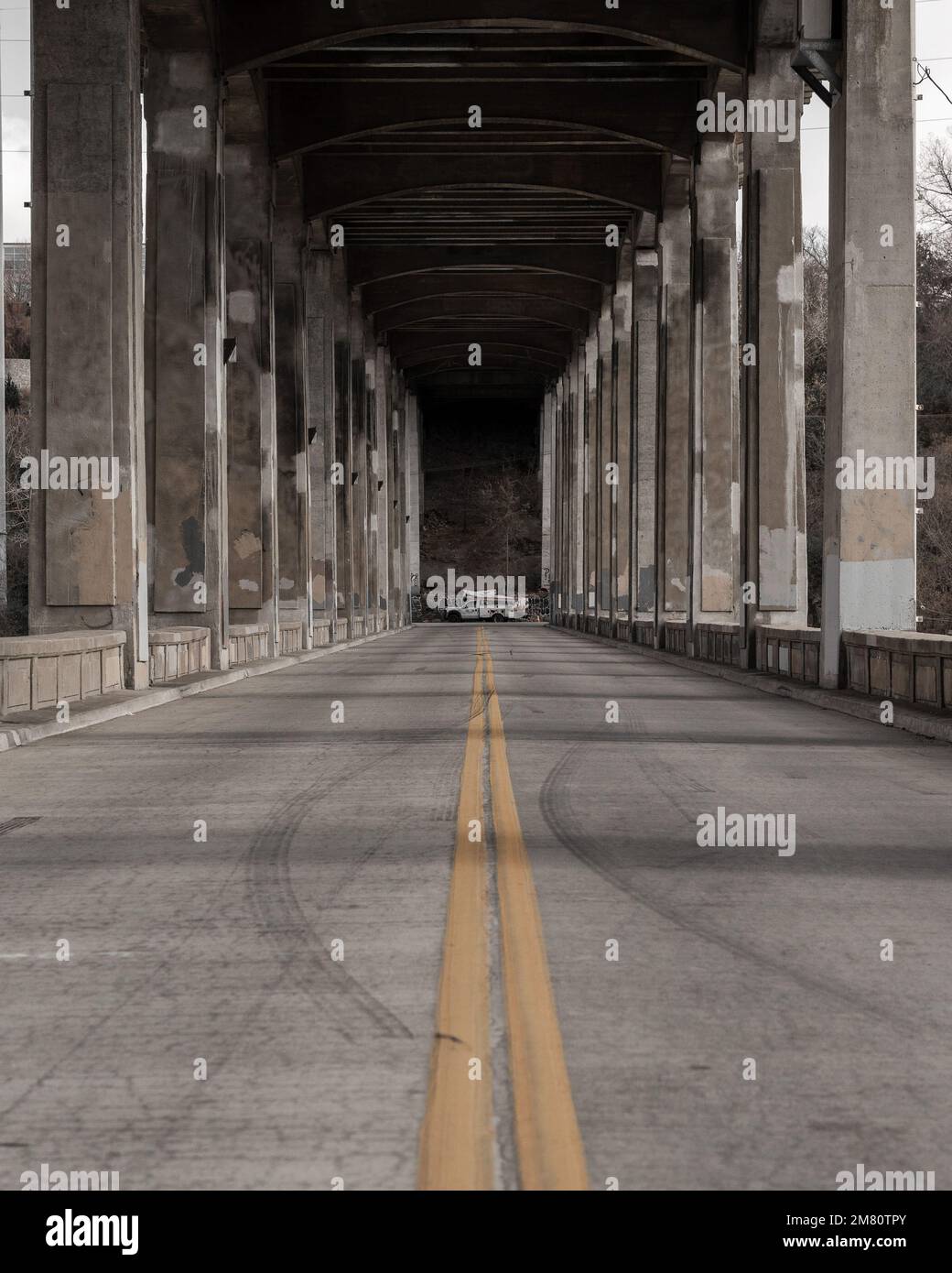 A Straight parallel lines Road between stone columns for cars Stock ...