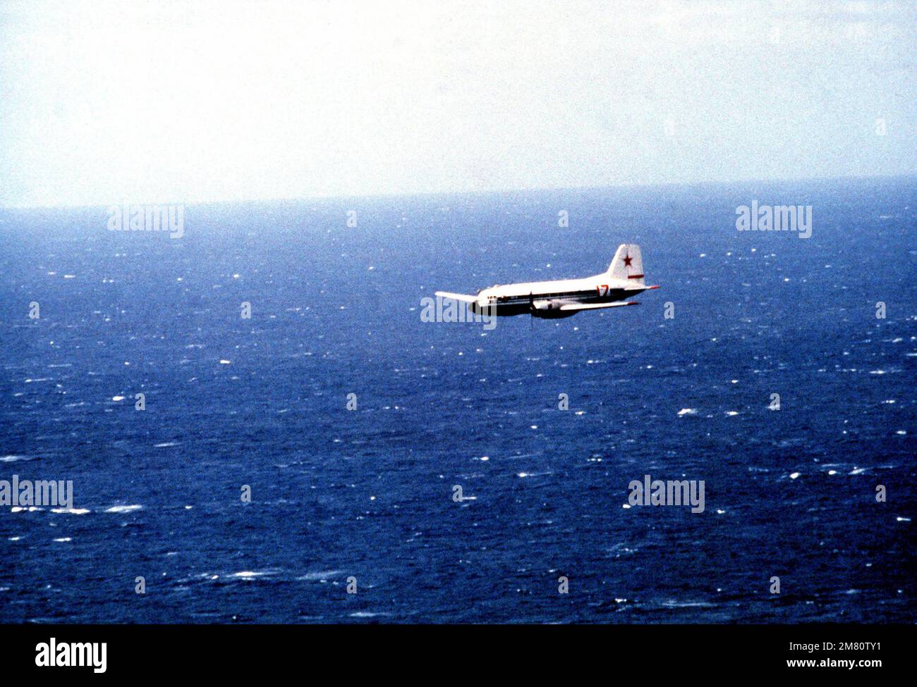 An air-to-air left side view of a Soviet I1-14 Crate aircraft involved ...