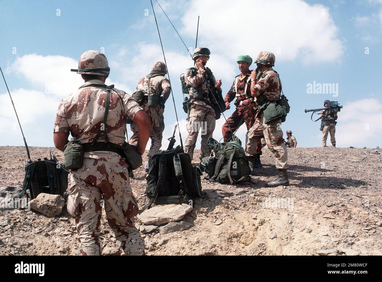 An Egyptian soldier observes American soldiers communicating with ...