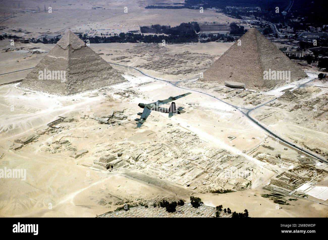 An air-to-air left rear view of a B-52 bomber aircraft as it flies over ...