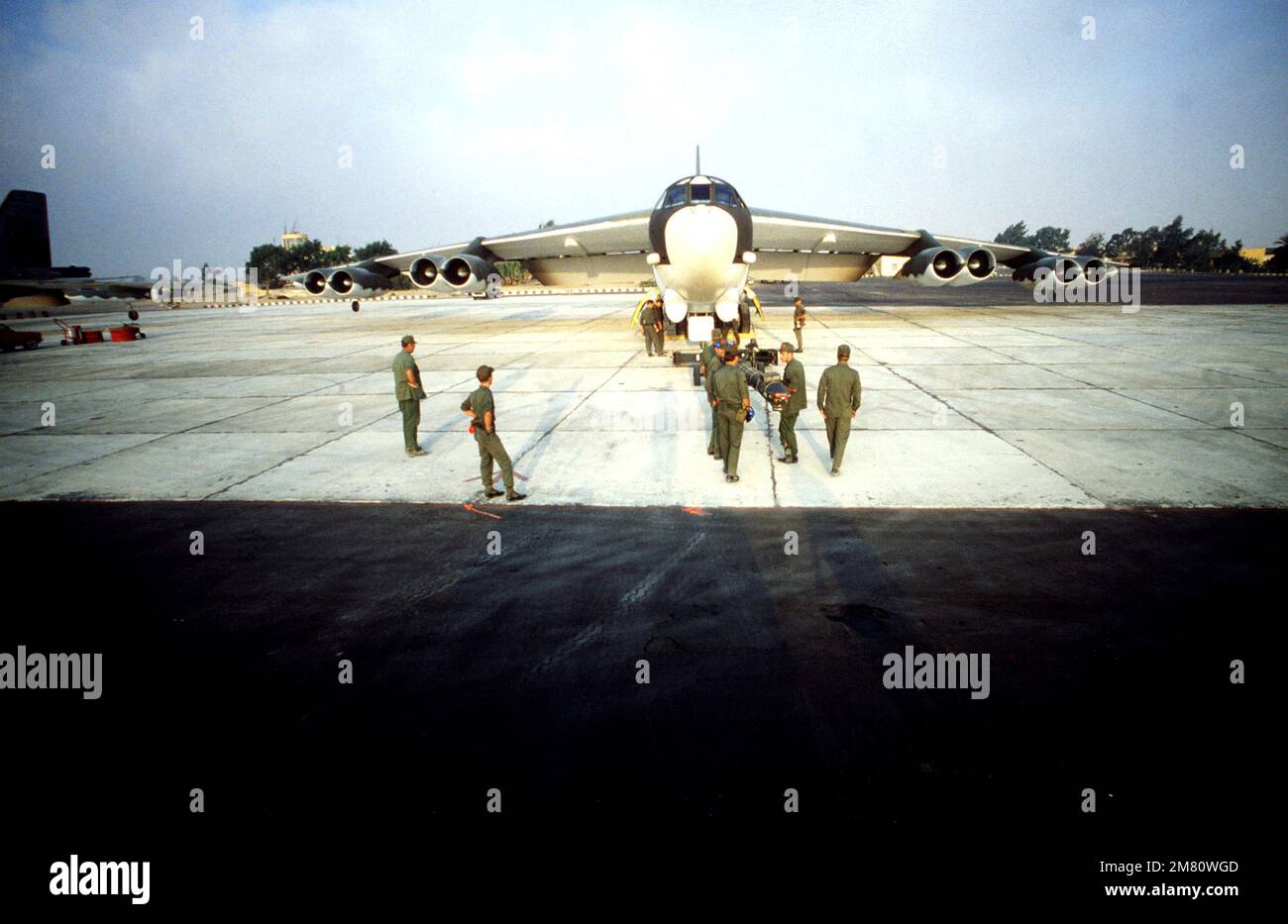 A front view of a B-52 bomber aircraft as ground crewman perform ...
