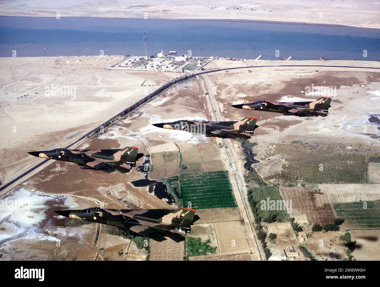 An air-to-air left side view of four F-111 aircraft in use during ...