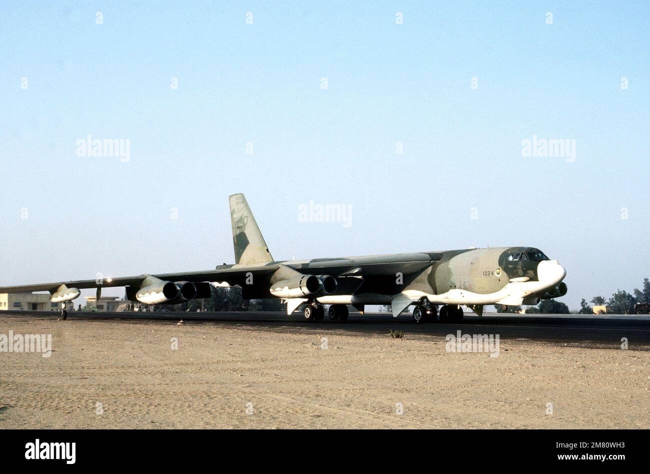 A right front view of a B-52 bomber aircraft as it taxis out onto the ...
