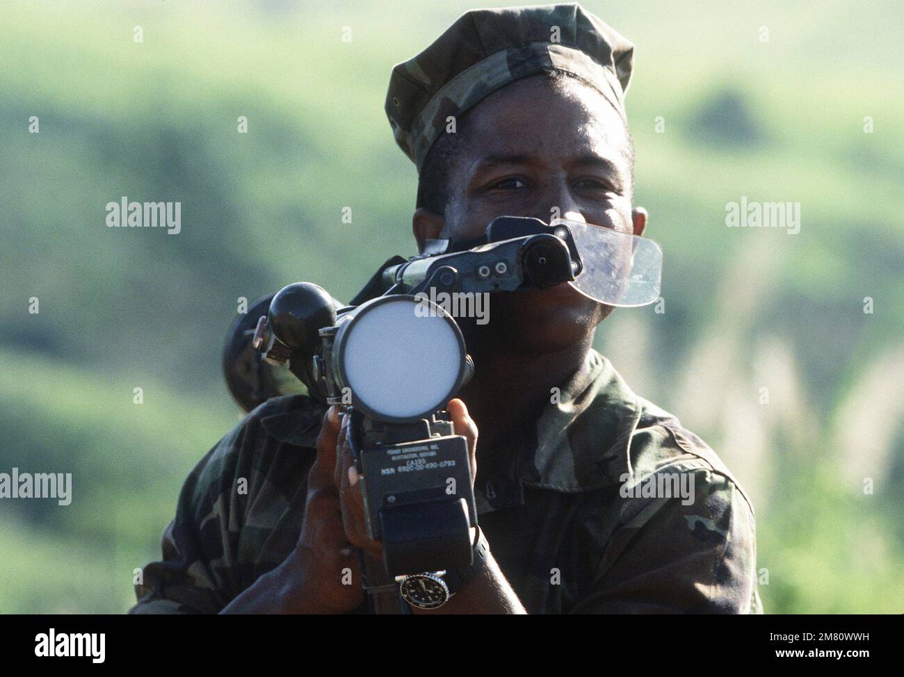 A Marine prepares to fire a laser training version of a Redeye portable ...