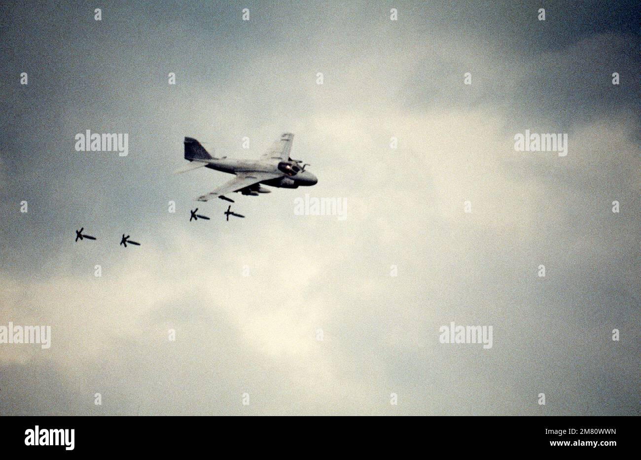 An air-to-air right side view of an A-6 Intruder aircraft as it drops ...