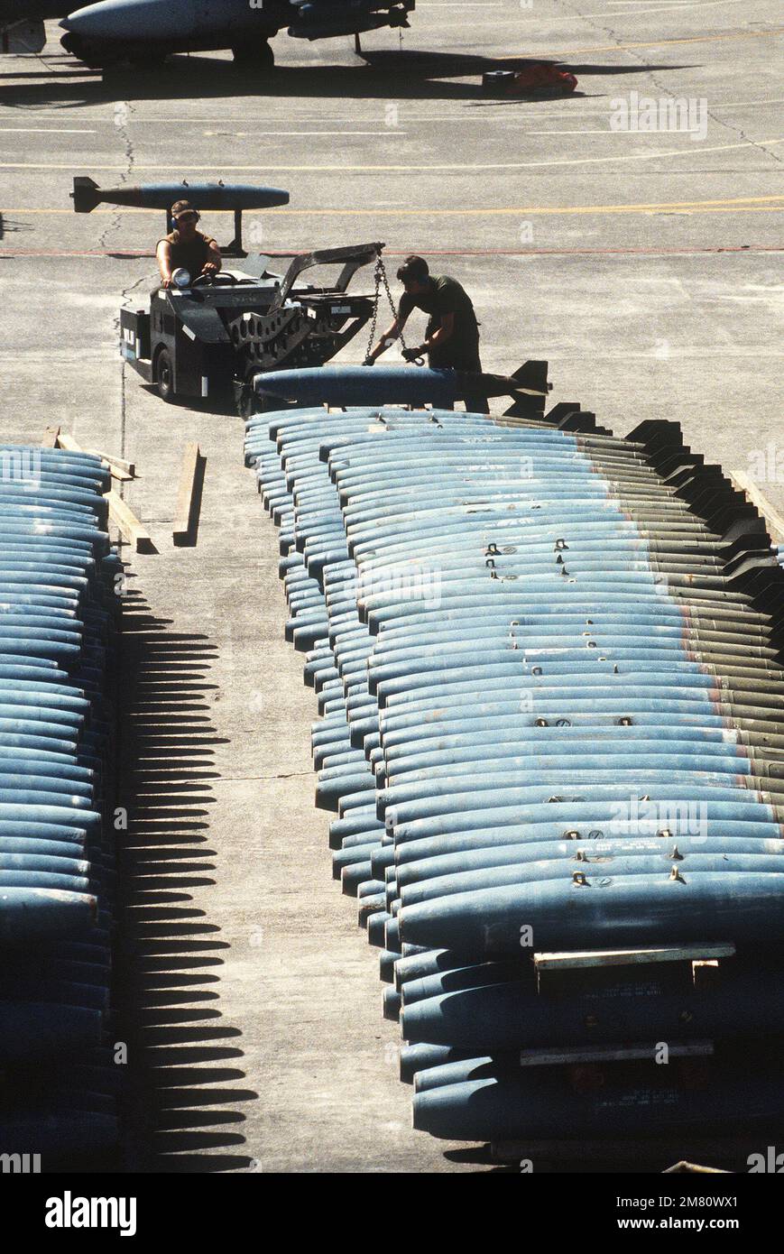 Ground crewmen use a bomb loader to pick up a Mark 82 500-pound ...
