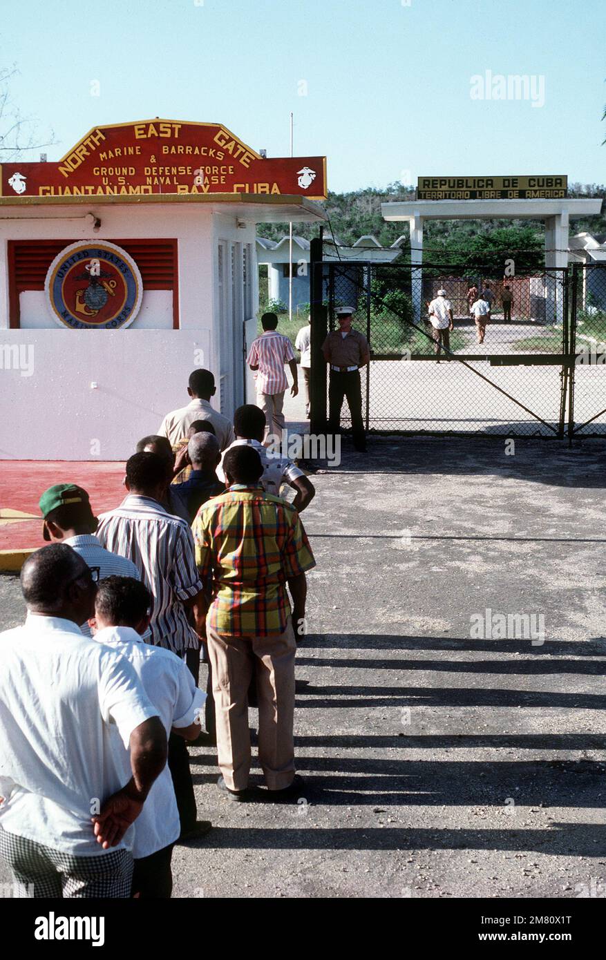 A member of the Marine Barracks Ground Defense Force checks civilian ...