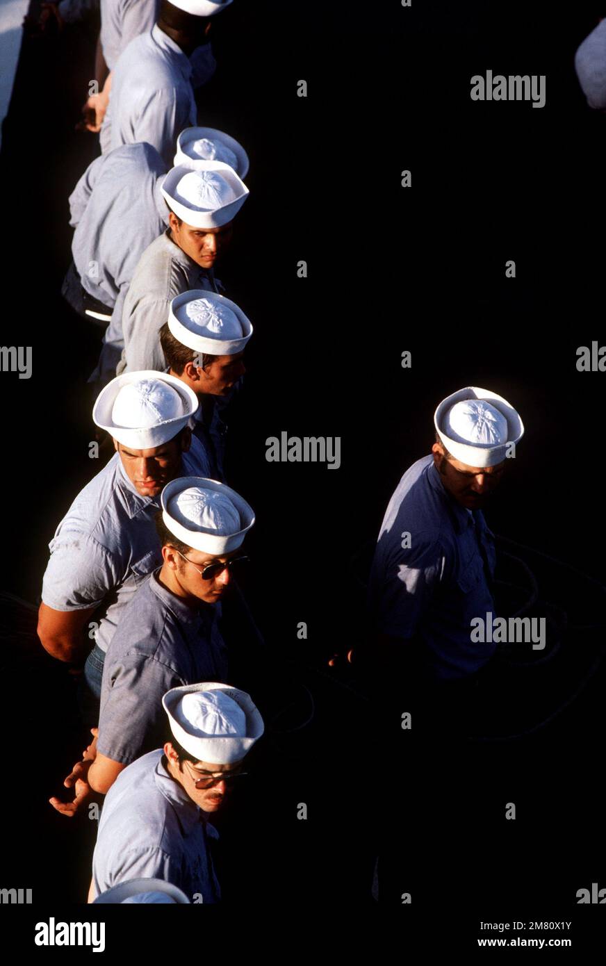 Sailors stand at ease in the ranks during an inspection aboard the ...