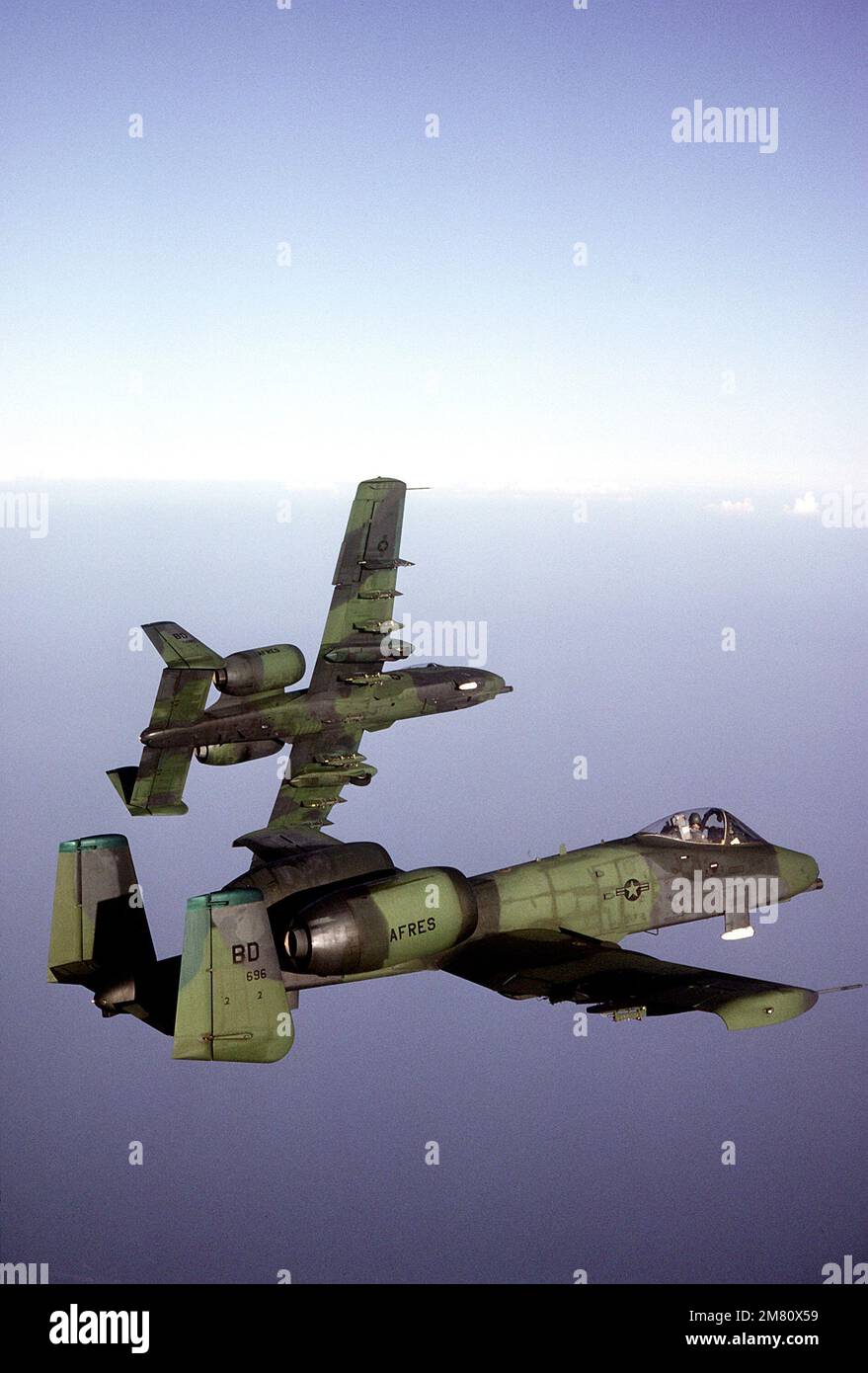 An air-to-air view of an A-10 Thunderbolt II aircraft banking to the ...