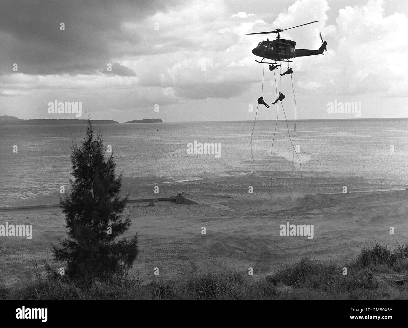 Marines rappel from a UH-1N Iroquois helicopter during a training ...