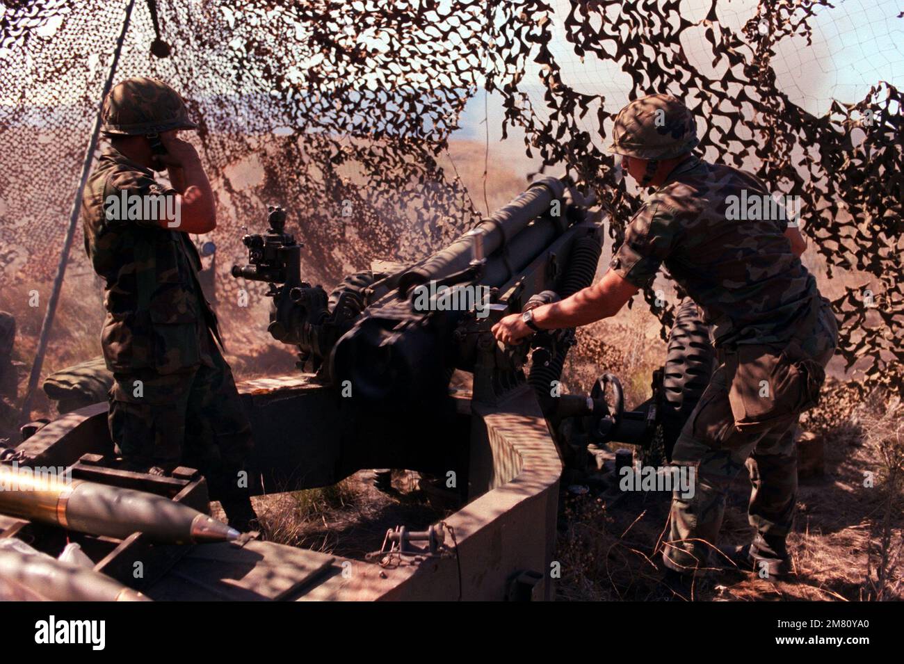 Private First Class George Darlington covers his ears as Private 2 Jeff ...